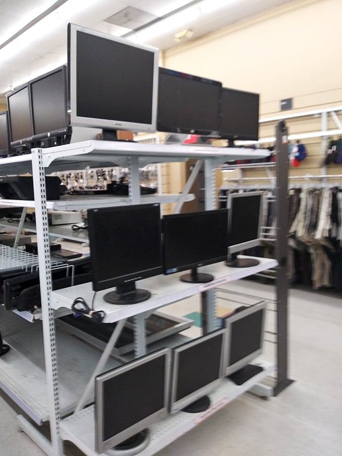 Computer monitors stacked like technological trading cards—yesterday's cutting edge becoming today's affordable option for budget-conscious shoppers.