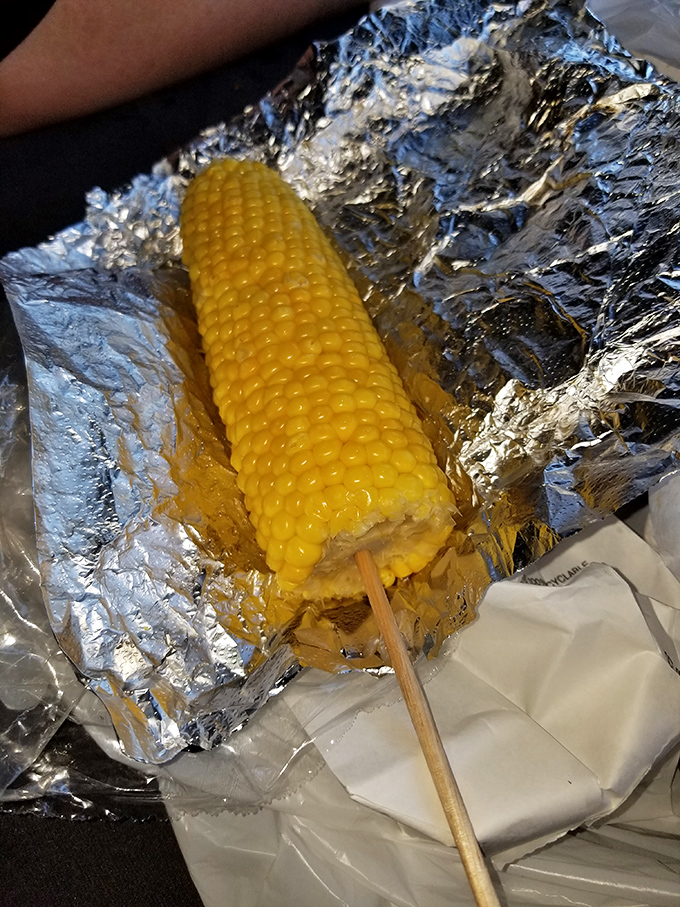 Corn on the cob wrapped in foil—nature's perfect side dish, ready to complement that crispy chicken with sweet, buttery simplicity.