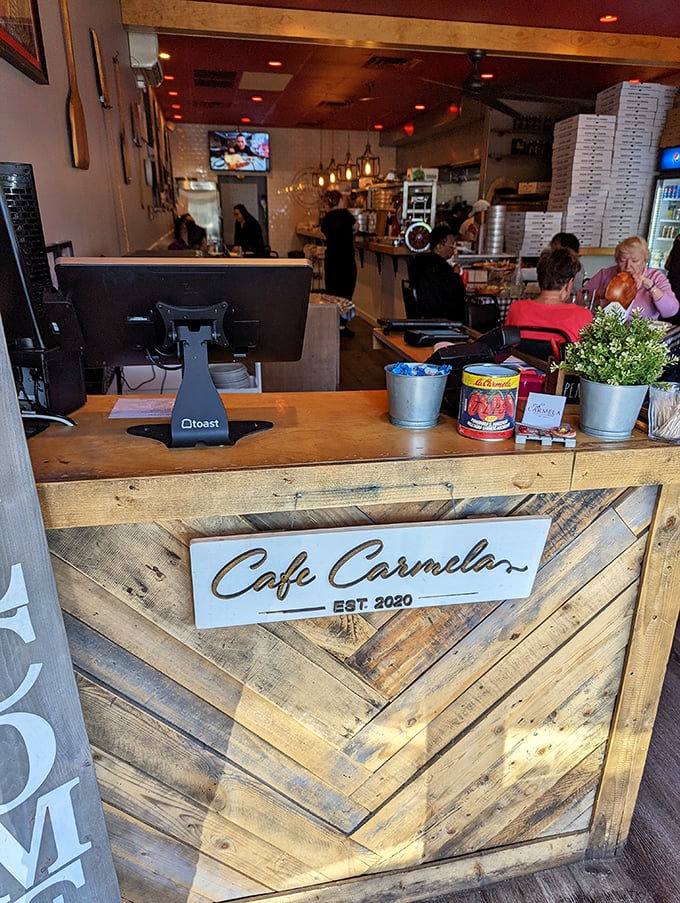 The rustic wooden counter tells you everything about Café Carmela's priorities—warmth, craftsmanship, and the kind of authenticity you can't fake.