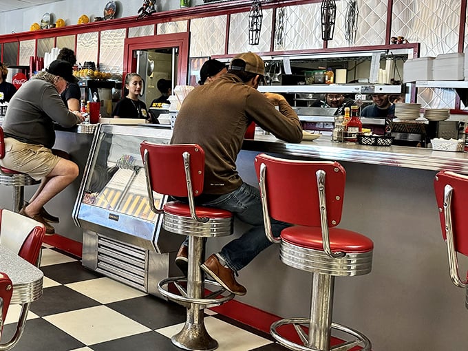 The counter seats—where solo diners become temporary family and the coffee refills flow like conversation. Breakfast theater at its finest.