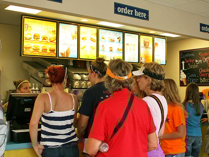 The universal language of anticipation—hungry visitors studying the menu like it's a treasure map to flavor paradise.