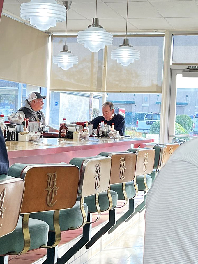 The counter crowd knows the secret—grab a seat where you can watch your breakfast being made while trading friendly banter with regulars.