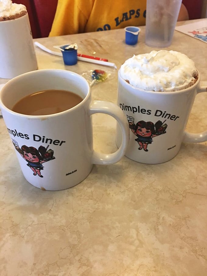 Coffee mugs that tell you exactly where you are, in case the food coma makes you temporarily forget. One black, one with whipped cream—life choices.
