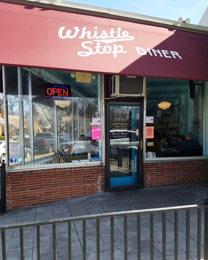 The red awning and neon "OPEN" sign—a beacon of breakfast hope on mornings when your coffee maker mysteriously stops working.