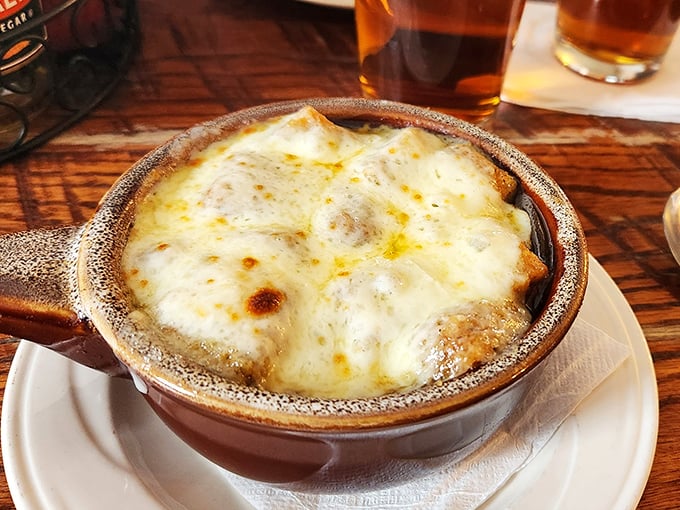 French onion soup done right—a bubbling cauldron of comfort that's worth the inevitable cheese-pull photo opportunity.
