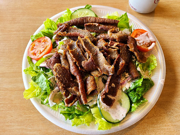 A gyro salad that proves healthy eating doesn't mean sacrificing flavor—tender meat atop crisp greens creates the perfect guilt-free indulgence.
