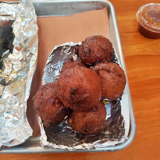 Hush puppies so perfectly golden they look like edible sunshine—crispy outside, tender inside, and utterly addictive.