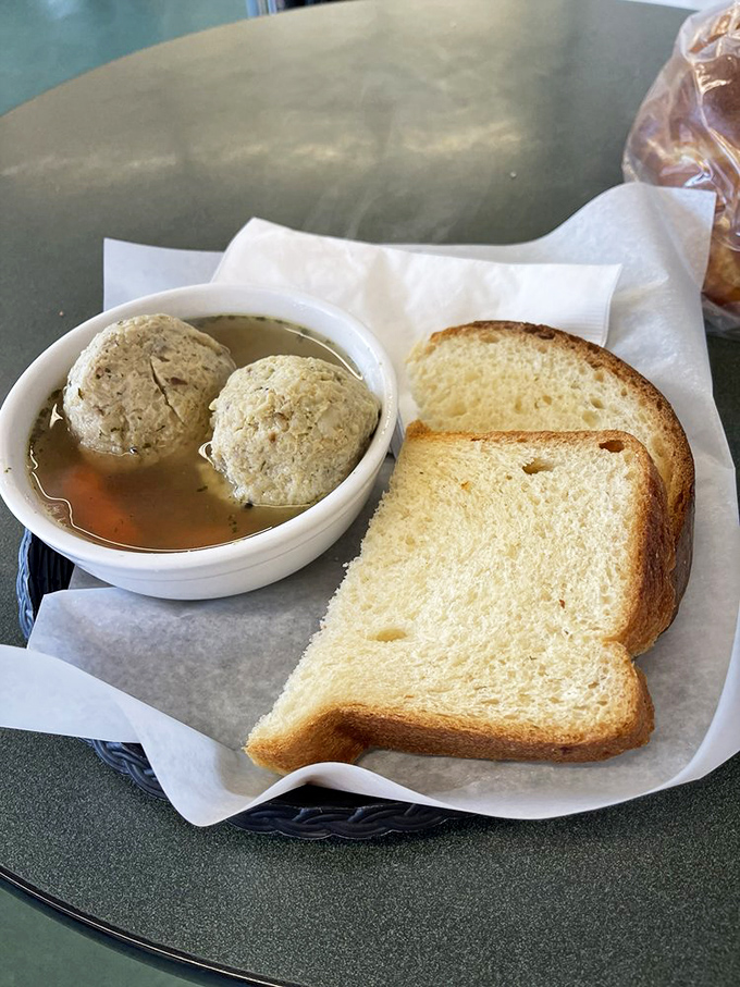 Matzo ball soup: Jewish penicillin that cures whatever ails you. Those dumplings aren't just floating—they're performing a comfort food ballet.