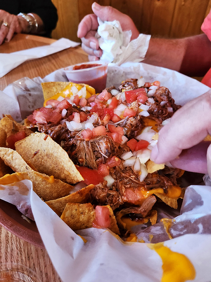 Nachos that require strategy – each chip a potential vehicle for the perfect ratio of pulled pork, cheese, and fresh pico de gallo.