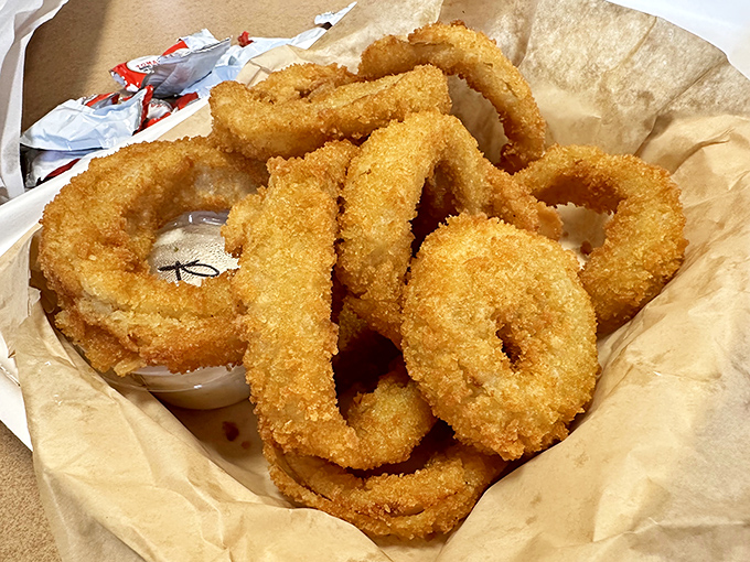 Onion rings with the golden ratio of crunch-to-tenderness. These aren't just sides—they're main attractions that happen to be circular.