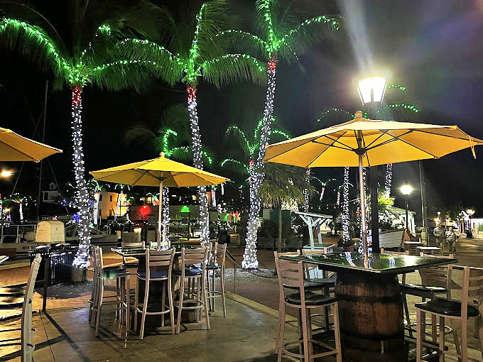 Palm trees wrapped in lights create the perfect tropical nightcap setting. Even the umbrellas look relaxed.