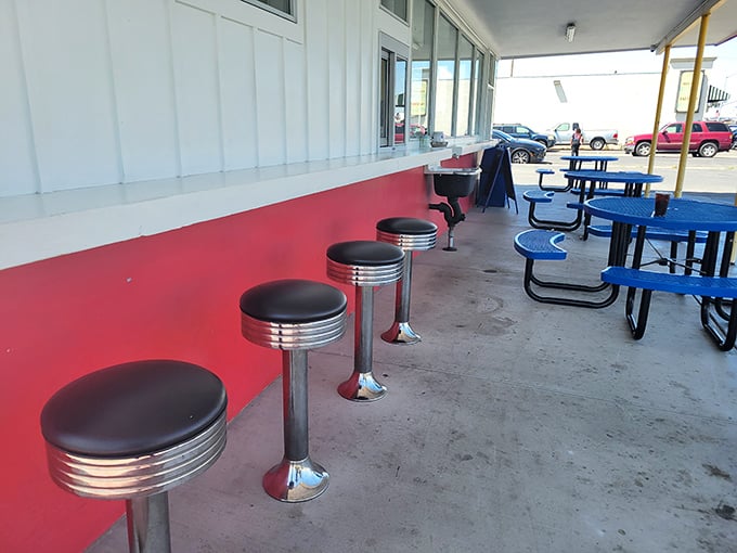 The outdoor counter with classic diner stools—where strangers become friends united by the universal language of "mmm" and "pass the ketchup."