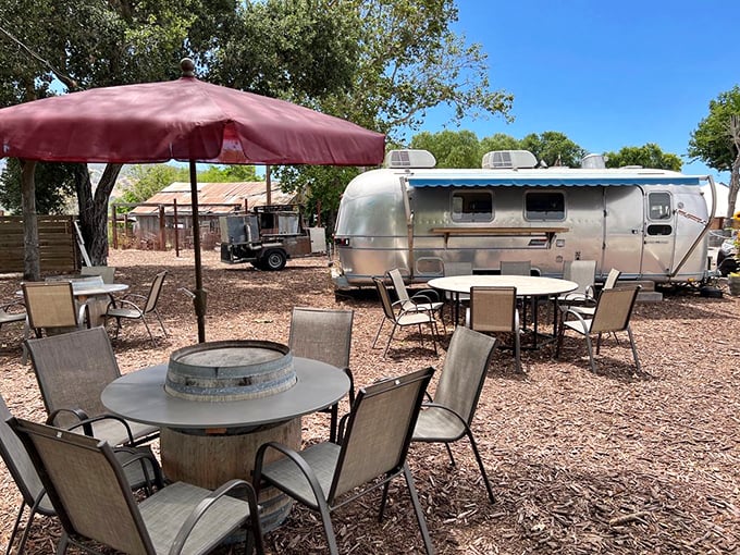 Outdoor seating with rustic charm and an Airstream backdrop. Wine country al fresco dining that feels like a movie set.