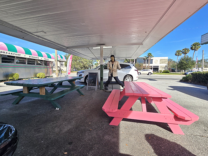 Outdoor picnic tables painted the color of flamingos—because in Florida, even your lunch seating should remind you you're in paradise.