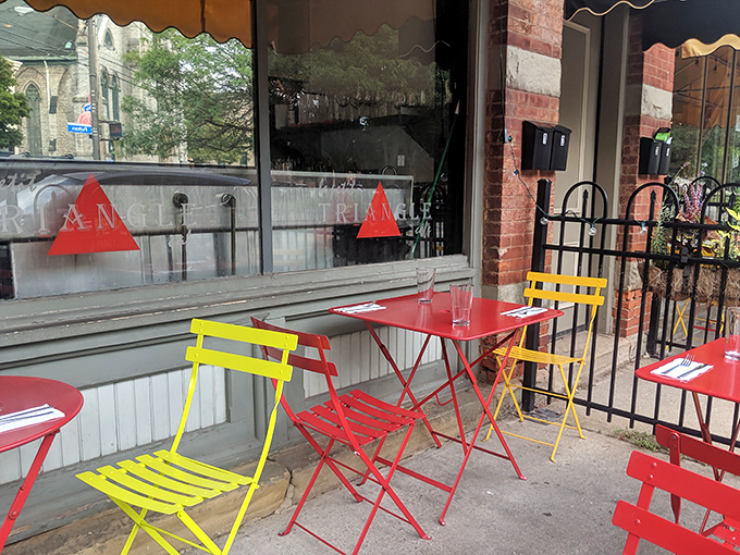 Colorful outdoor seating brings Parisian sidewalk cafe culture to Cleveland—red and yellow chairs practically shouting "Bonjour!" to passersby.