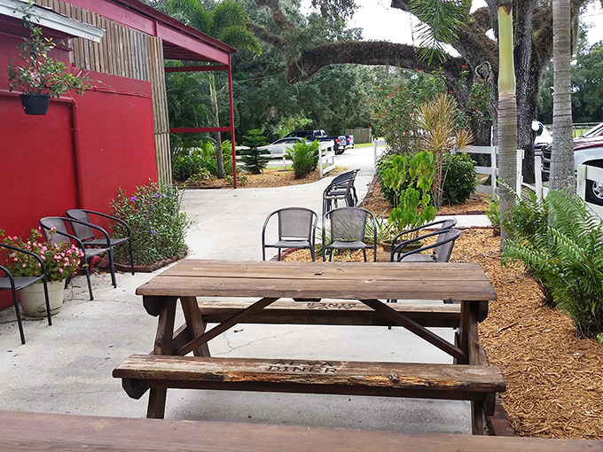 Florida's outdoor dining done right – picnic tables and palm trees creating a perfect spot for between-meal conversations or pre-meal anticipation.