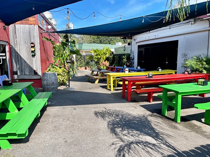 The outdoor oasis where rainbow-colored picnic tables invite you to linger long after your plate is clean.