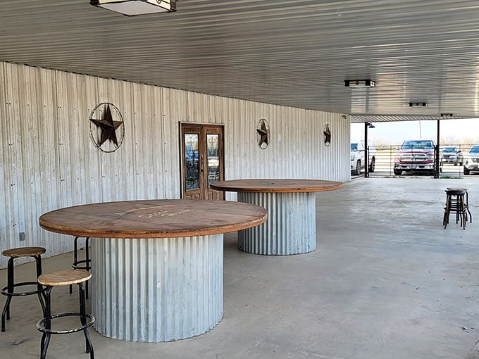 Outdoor seating features circular tables made from repurposed metal—where conversations and digestive recovery happen under the Texas sky.