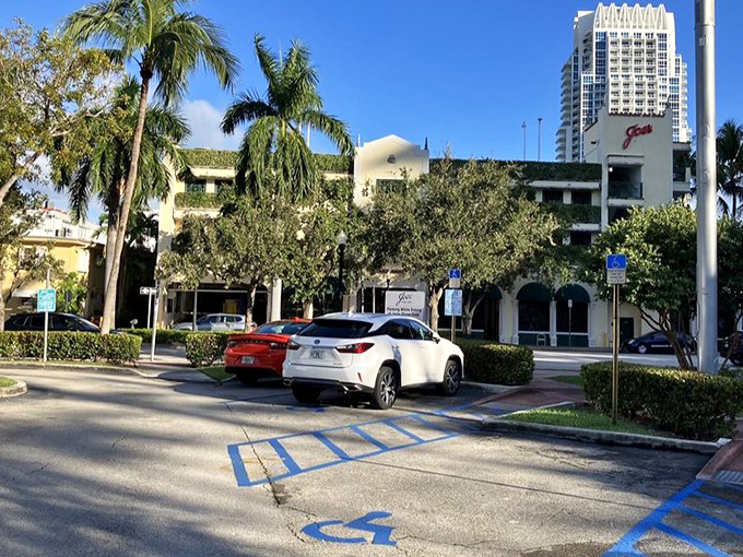 Even the parking lot feels distinctly Miami Beach—palm trees standing sentinel over vehicles whose owners are about to have a memorable meal.