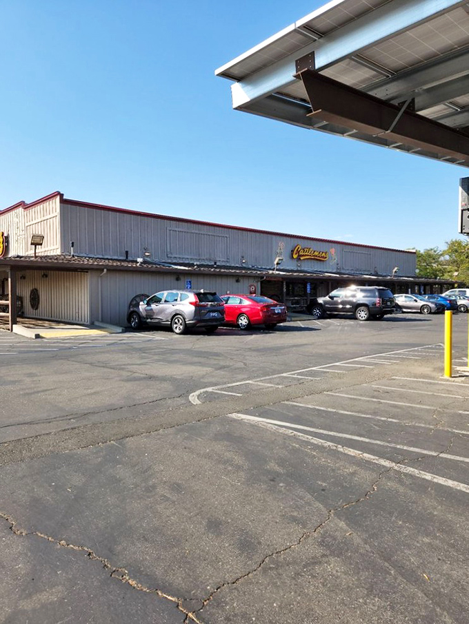 The parking lot might not win beauty contests, but it serves its purpose—a humble gateway to the flavor explosion waiting inside those wooden doors.