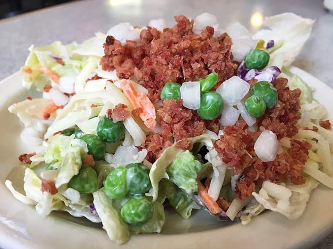 This isn't just coleslaw—it's a carnival of textures and flavors with peas, bacon bits, and a creamy dressing that makes vegetables worth celebrating.