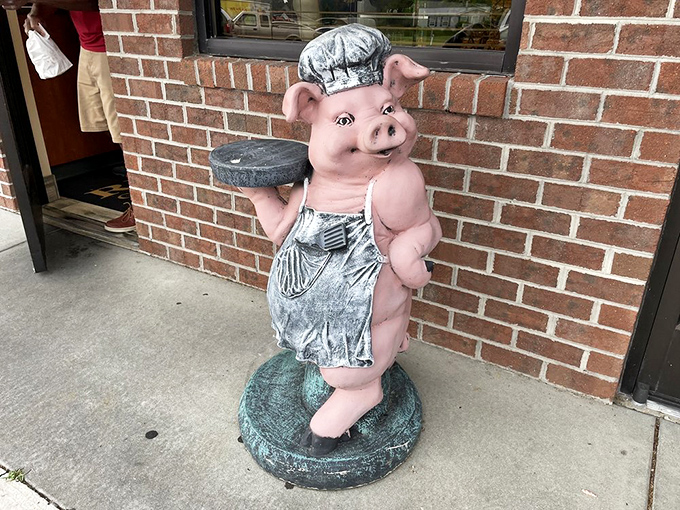 Meet the unofficial greeter—a chef pig statue who's been welcoming hungry patrons longer than most servers have been alive.