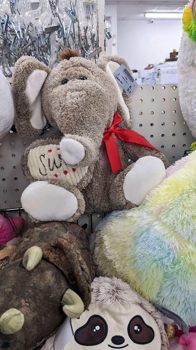 Stuffed animals with price tags for ears wait for second chances at cuddle-time – that elephant has seen some things but kept his red bow tie.