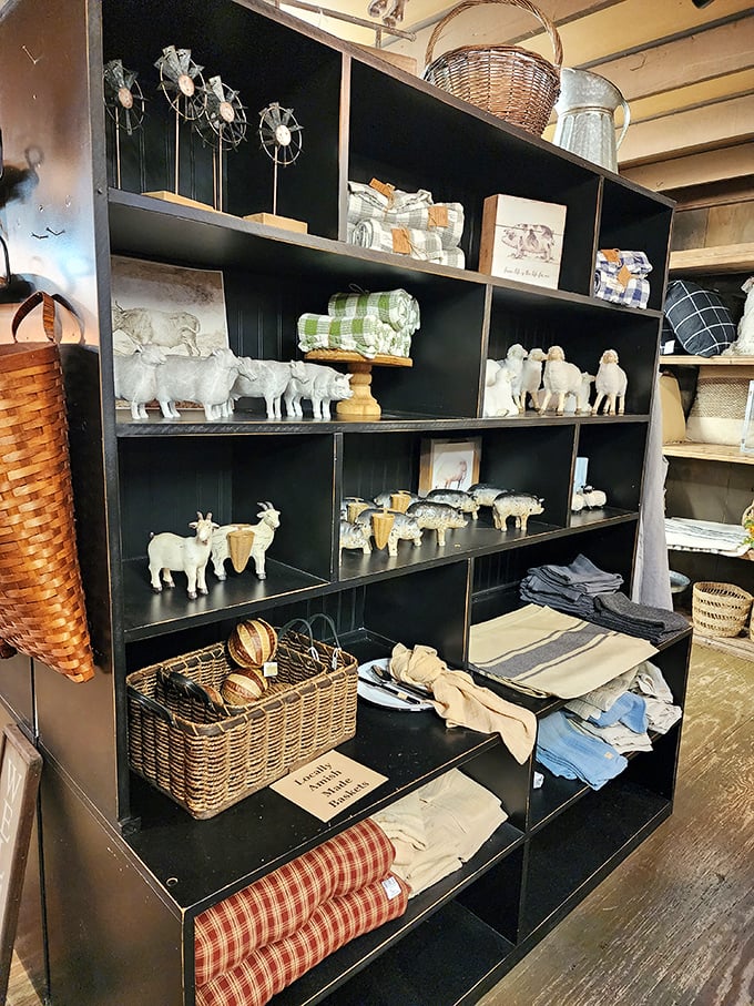 Farm animal figurines stand at attention on black shelving, ready to bring country charm to urban apartments.