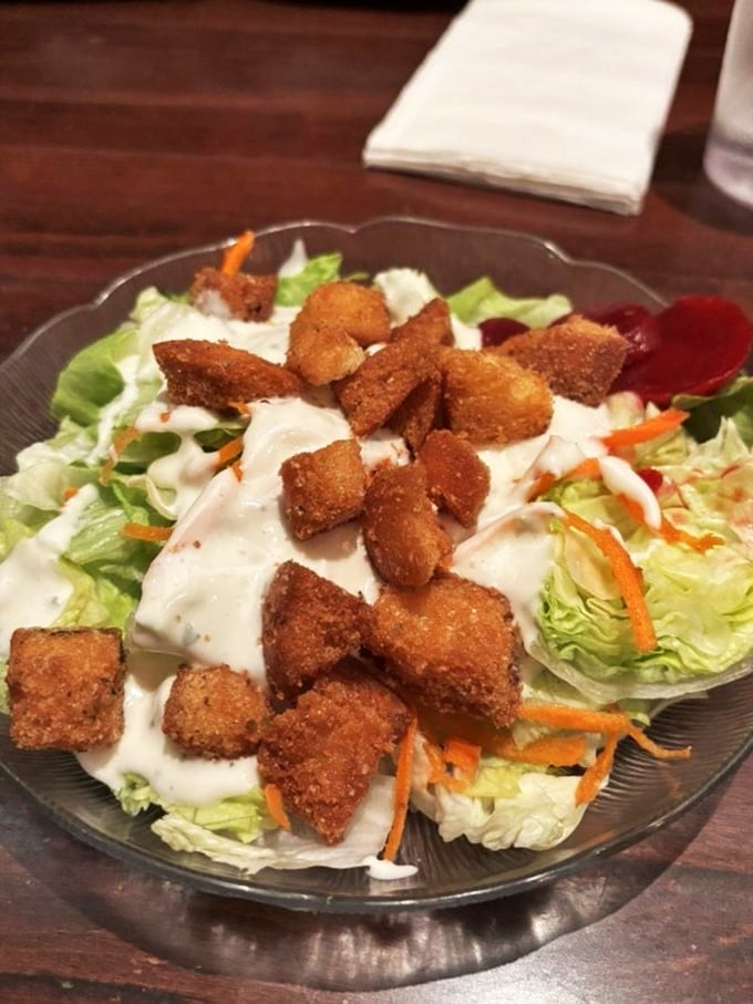This generous salad topped with golden croutons proves that even the lighter options here don't skimp on satisfaction.
