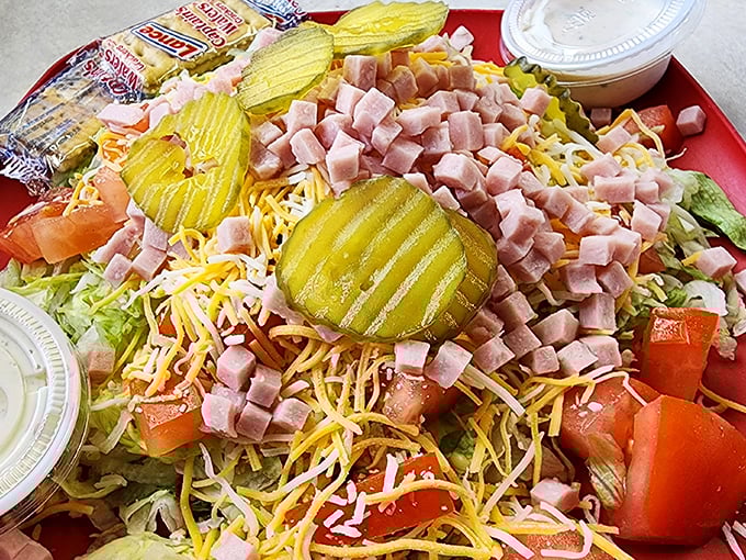 This isn't just a chef salad – it's a celebration. Those pickle chips stand like flavor sentinels guarding a kingdom of ham, cheese, and fresh veggies.