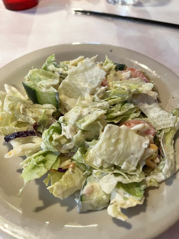 A salad that understands its supporting role in the steakhouse experience—just enough greenery to justify the dessert you're already planning to order.