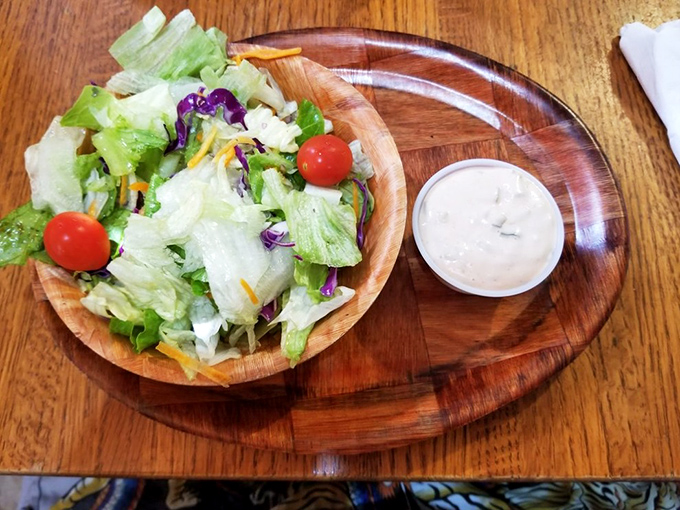 Even the salad has Southern charm—fresh, colorful, and served in a wooden bowl that somehow makes vegetables more appealing.