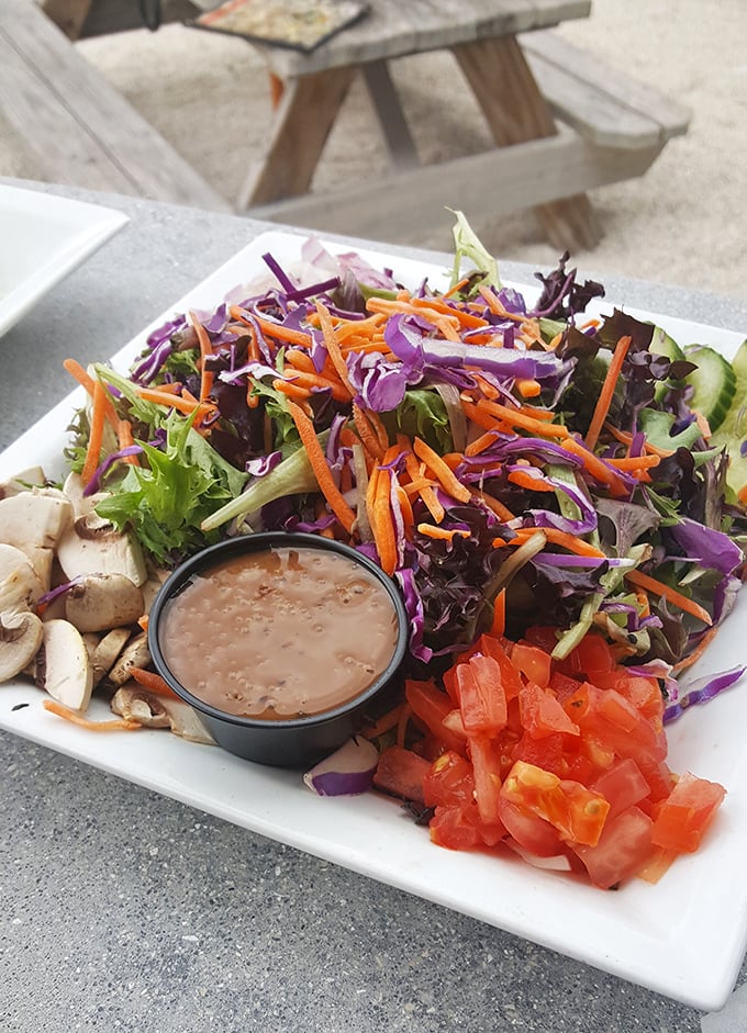 A salad that actually excites—vibrant vegetables, fresh mushrooms, and diced tomatoes that didn't come from some sad food service bag.
