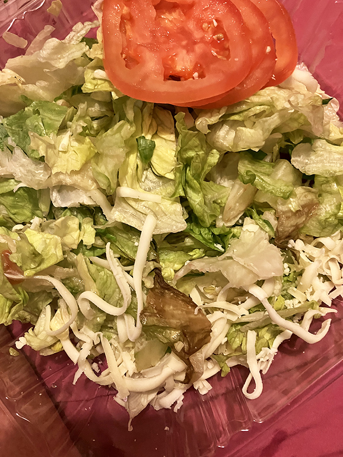 Fresh lettuce, crisp vegetables, and the promise of balance. Because sometimes you need a salad to justify that second slice of pizza.