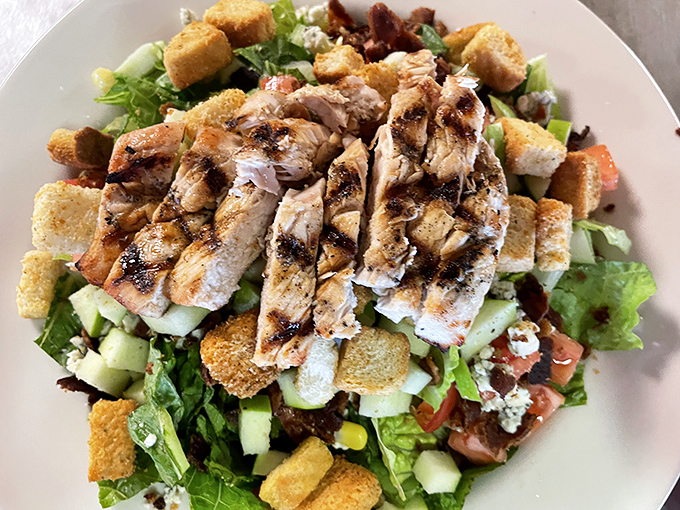 This isn't just a salad—it's a peace offering to your doctor after three days of BBQ indulgence, cleverly disguised with grilled chicken and crunchy croutons.