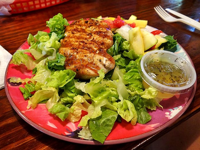 A salad that proves healthy eating doesn't have to be punishment – fresh greens cradling perfectly grilled protein with dressing that makes vegetables worth eating.