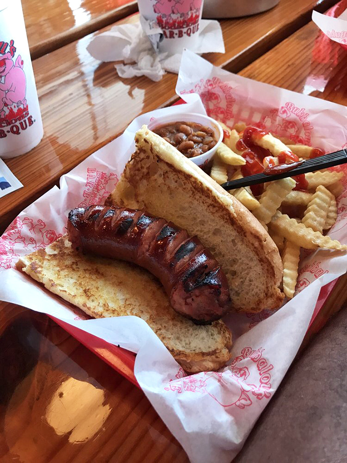 The sausage sandwich – where smoke-kissed meat nestles in a pillowy bun, accompanied by fries and beans that know their supporting role.