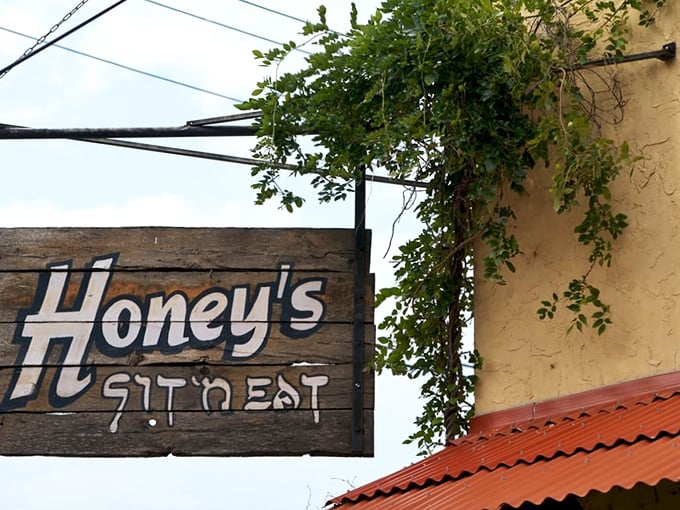 The sign says it all—simple, straightforward, and promising exactly what you need: a place to sit and eat food that makes you happy.
