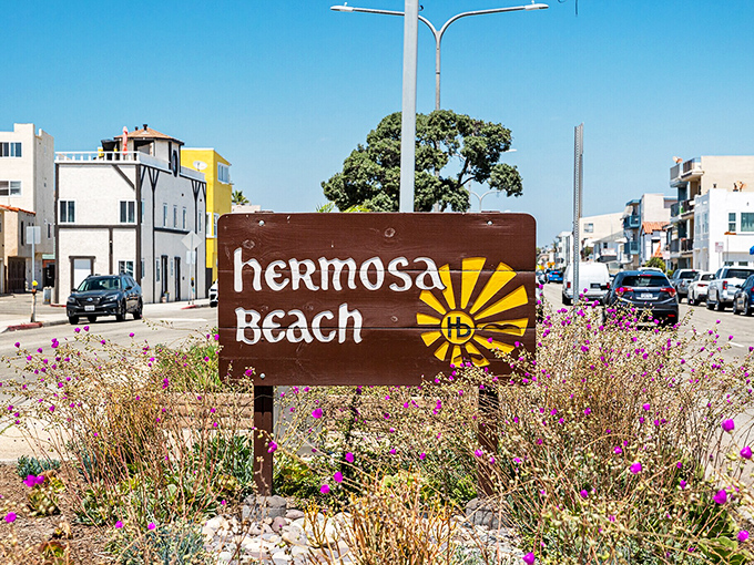 Hermosa's wooden welcome sign stands among wildflowers—a humble greeting that belies the extraordinary experiences waiting just beyond.