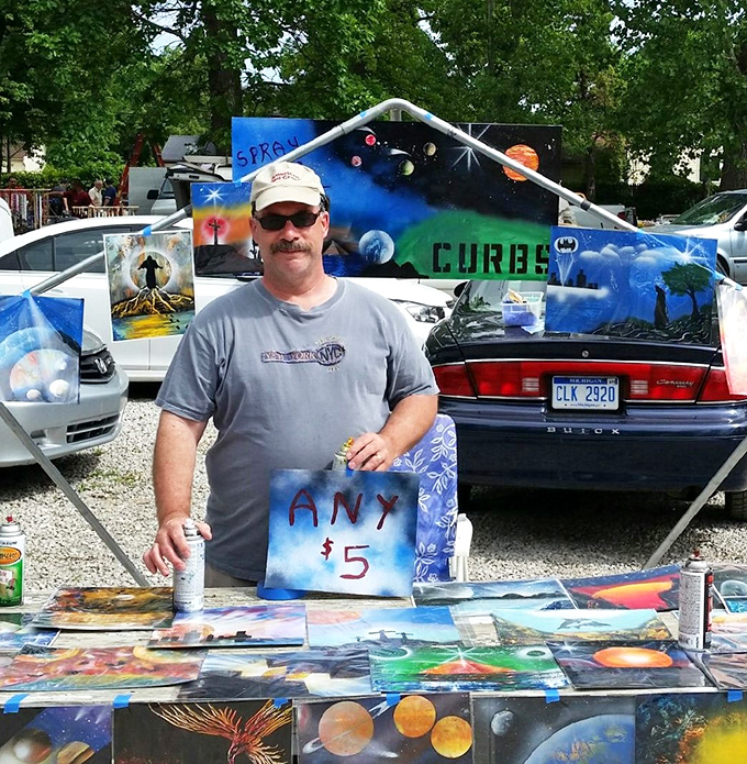 The cosmic artist's portable gallery—where $5 buys you a piece of spray-painted planetary wonder that somehow looks better at the flea market than at home.