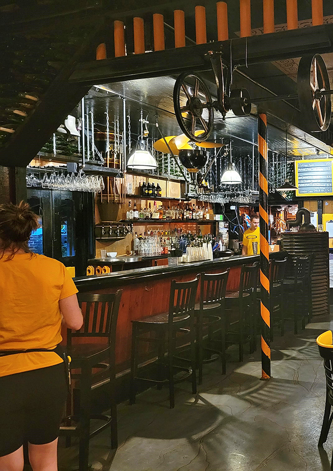 Vintage wheels and industrial elements hang above a well-stocked bar, where history and hospitality blend as smoothly as their craft cocktails.