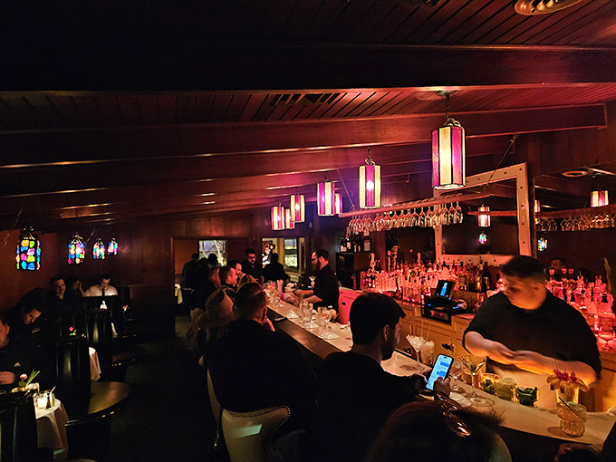 The bar buzzes with energy as patrons gather for pre-dinner libations. Those colorful pendant lights aren't just illumination—they're mood-setters for the evening ahead.