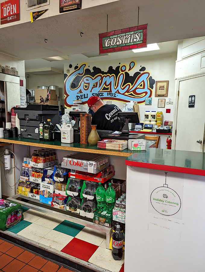 Behind this counter, sandwich magic happens daily. The colorful mural reminds you this isn't just lunch—it's a South Philly institution.