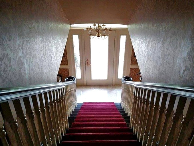 Descending these stairs feels cinematic—the red carpet treatment isn't just for Hollywood when you're staying at Georgian Manor.