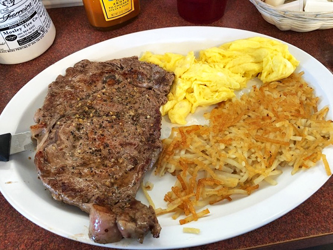 The breakfast steak and eggs plate—where a perfectly seasoned slab of beef meets fluffy scrambled eggs and hash browns crispy enough to make you weep.