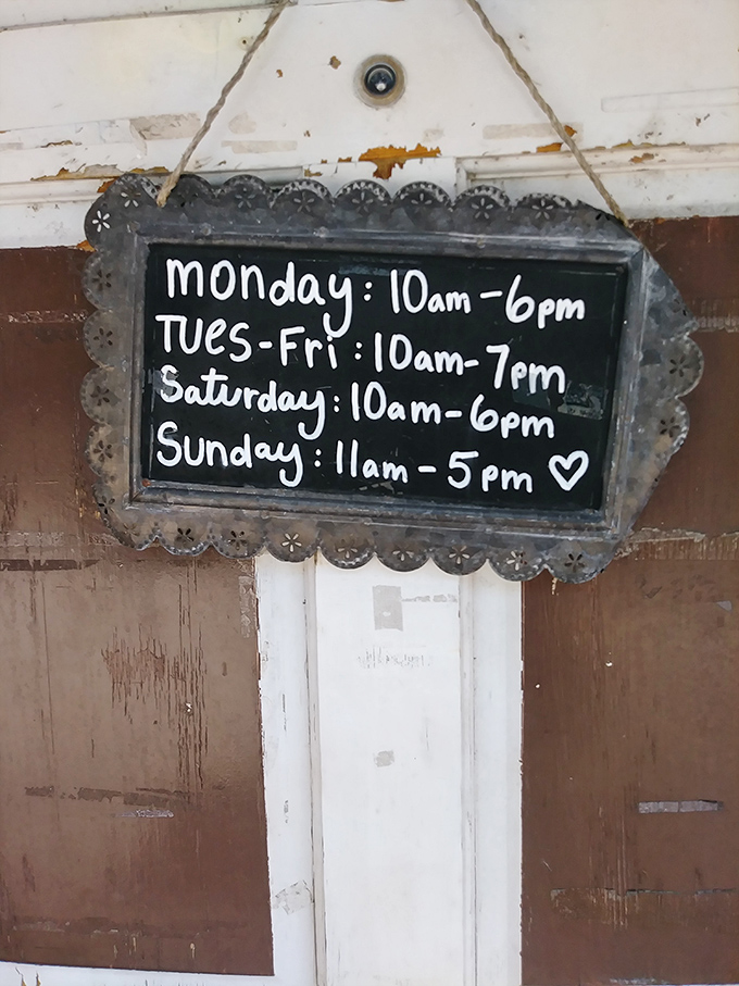 The store hours sign, with its hand-lettered charm and heart flourish, promises treasure-hunting opportunities almost every day of the week.
