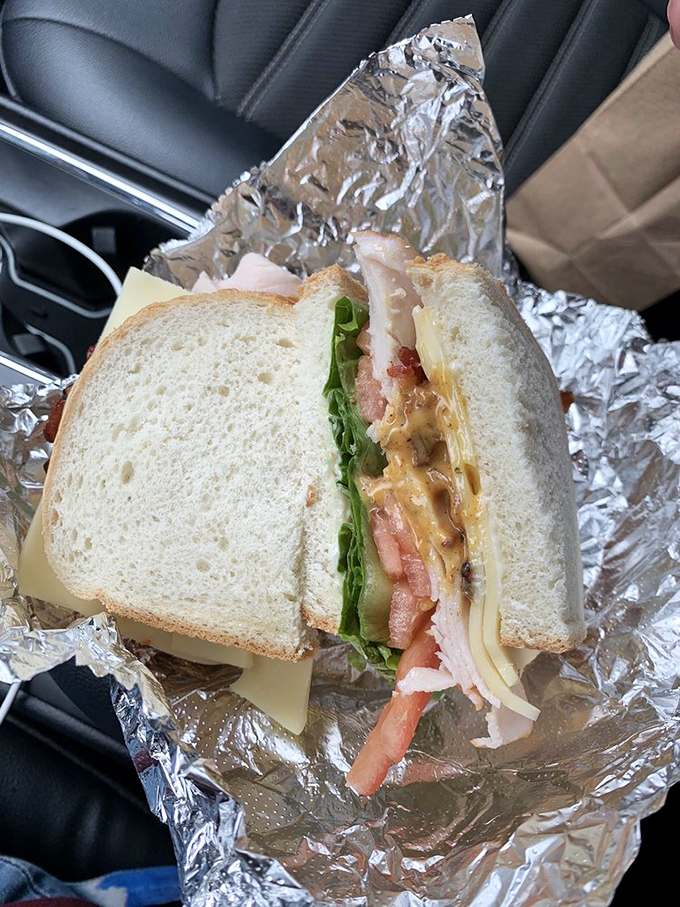 The turkey club in its natural habitat—your car. Some sandwiches are so good they don't even make it home. This is clearly one of them.