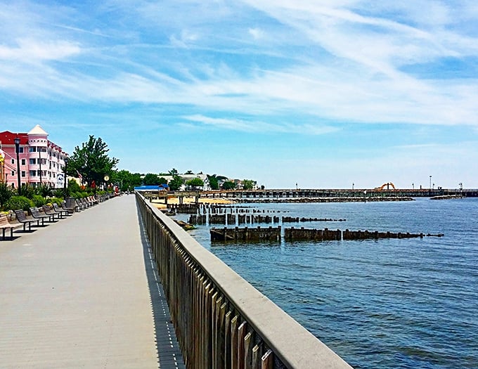 The boardwalk stretches like a promise along the shoreline – offering benches for contemplation and endless views for free.