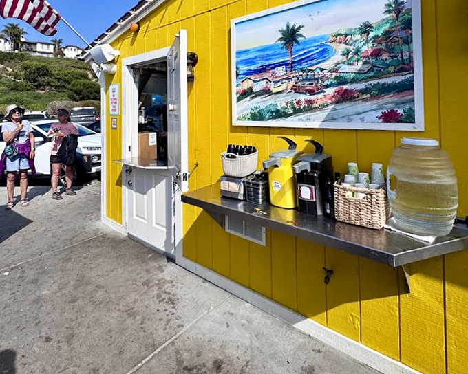 The sunshine-yellow shack isn't just a building – it's a beacon of milkshake happiness perched above the Pacific.