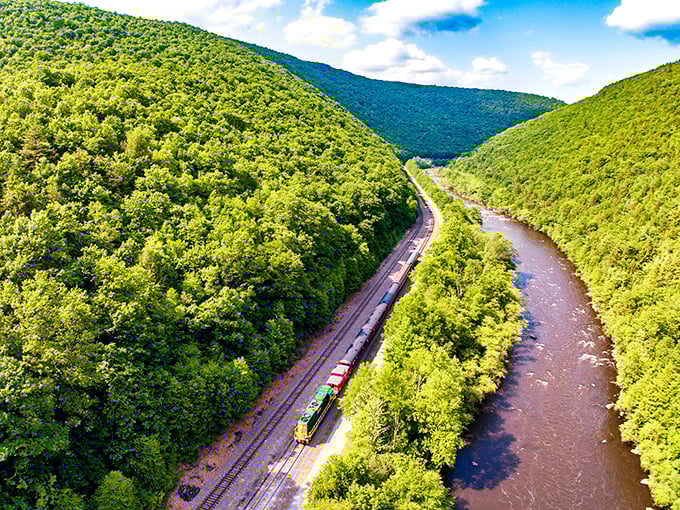 From above, the train appears as a tiny toy against nature's grandeur—a reminder that even our most impressive creations are dwarfed by Pennsylvania's beauty.